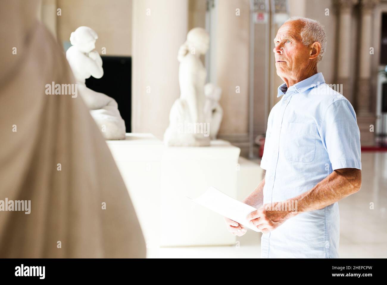 Man with guide at sculptures exposition Stock Photo - Alamy