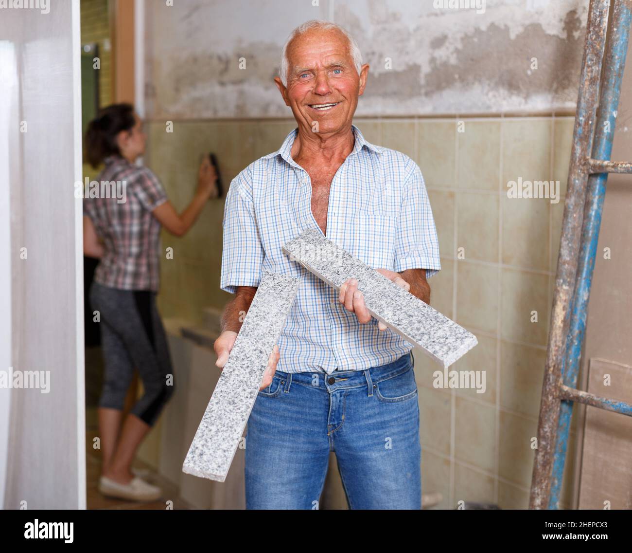 Man working on home renovations with daughter Stock Photo - Alamy