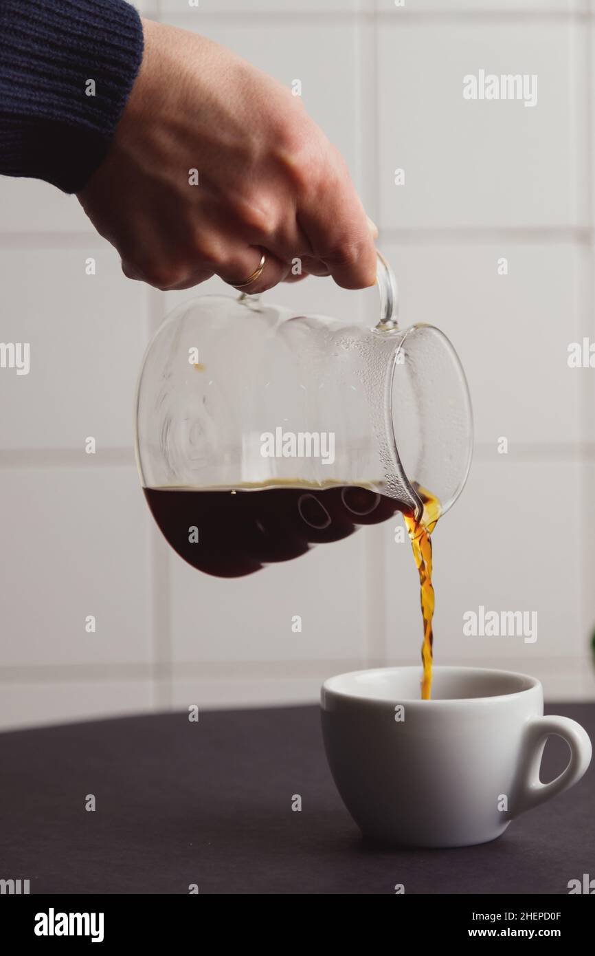 Hand pouring coffee hi-res stock photography and images - Alamy