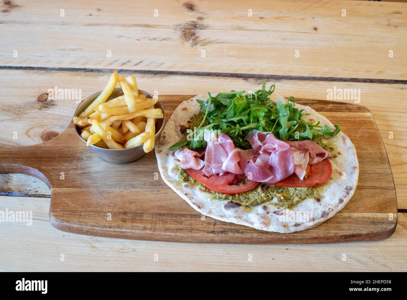 Delicious artisan ham salad wrap with pesto and rocket, served open on ...