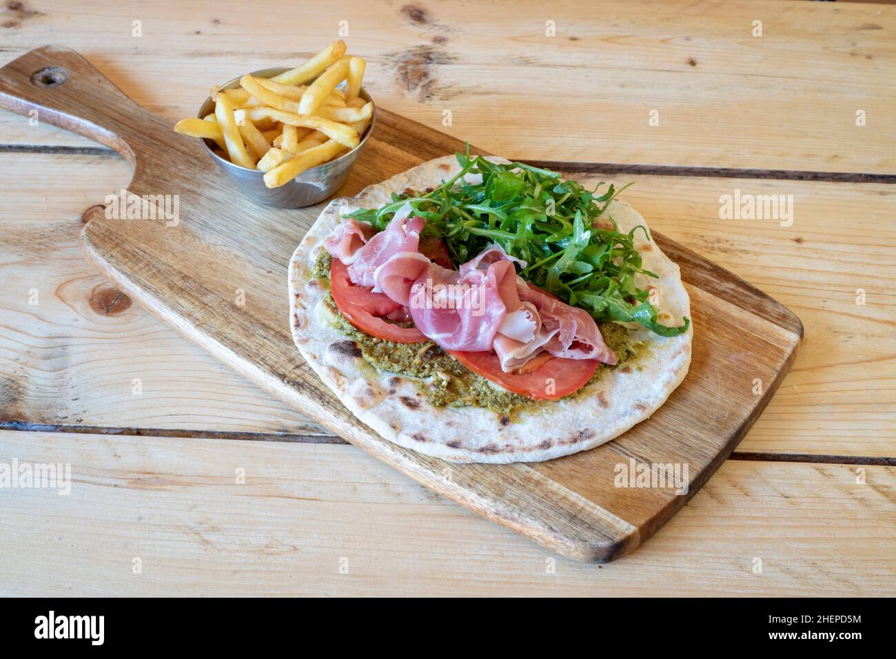 Delicious artisan ham salad wrap with pesto and rocket, served open on ...