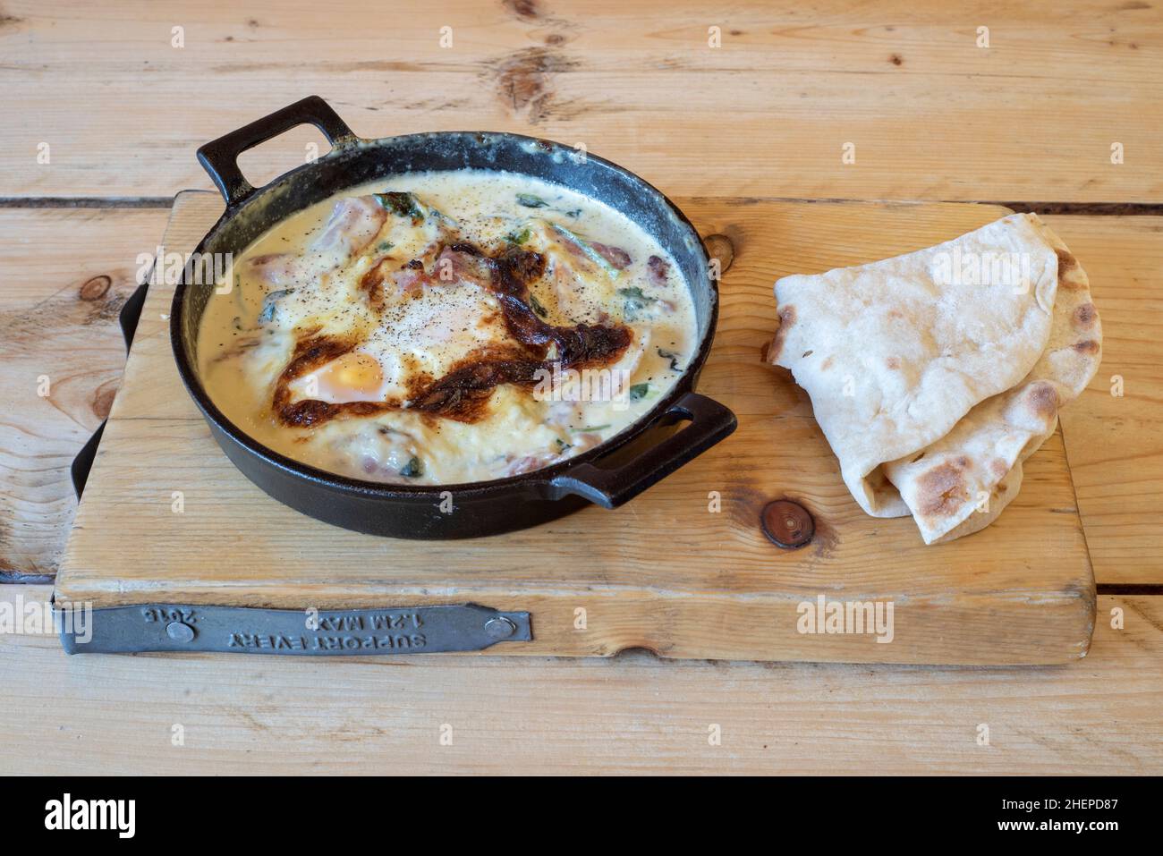 Cheesy Breakfast Special Sizzler egg and bacon in cheese sauce served ...