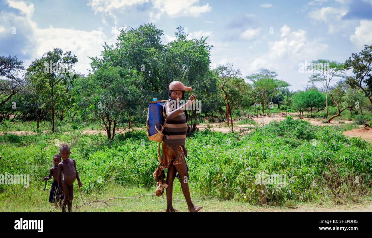 Tired Hamer Tribe Women coming back from Farm Work by the Green Rural ...