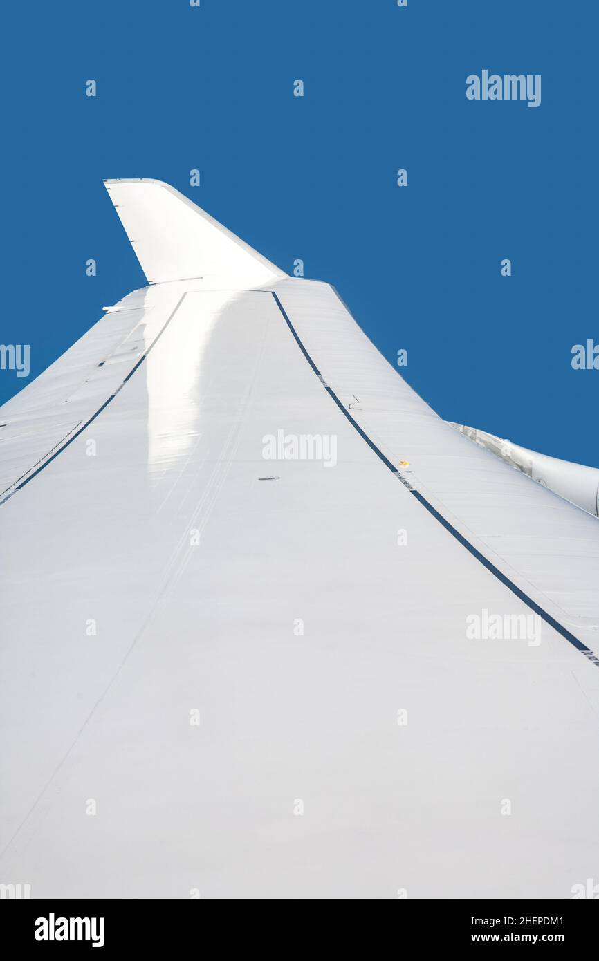 detail of aircraft wing in the air under clear blue sky Stock Photo - Alamy