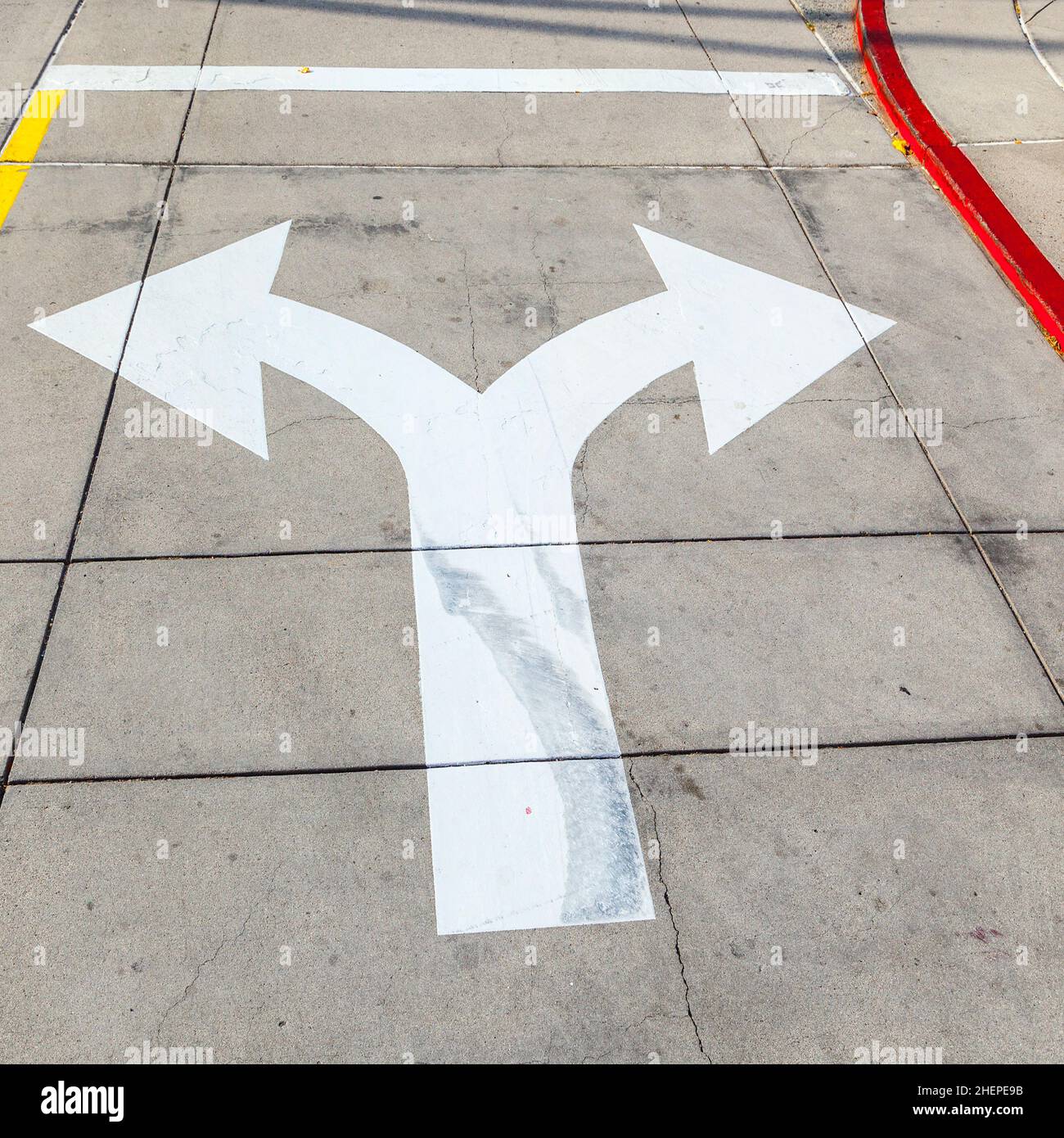 arrows and lines on the asphalt to indicate the direction of driving ...