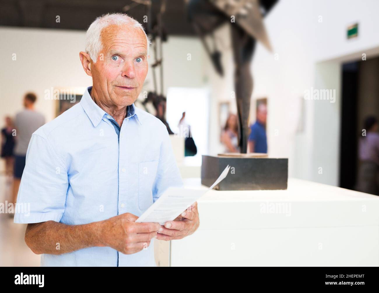 Man holding guide in museum Stock Photo - Alamy