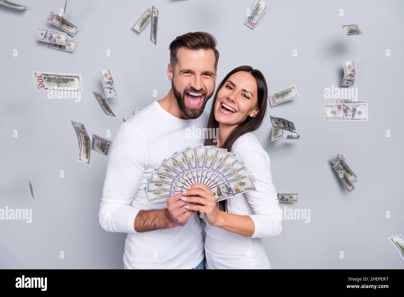 Photo of hooray young brunet couple win money wear white shirt isolated ...