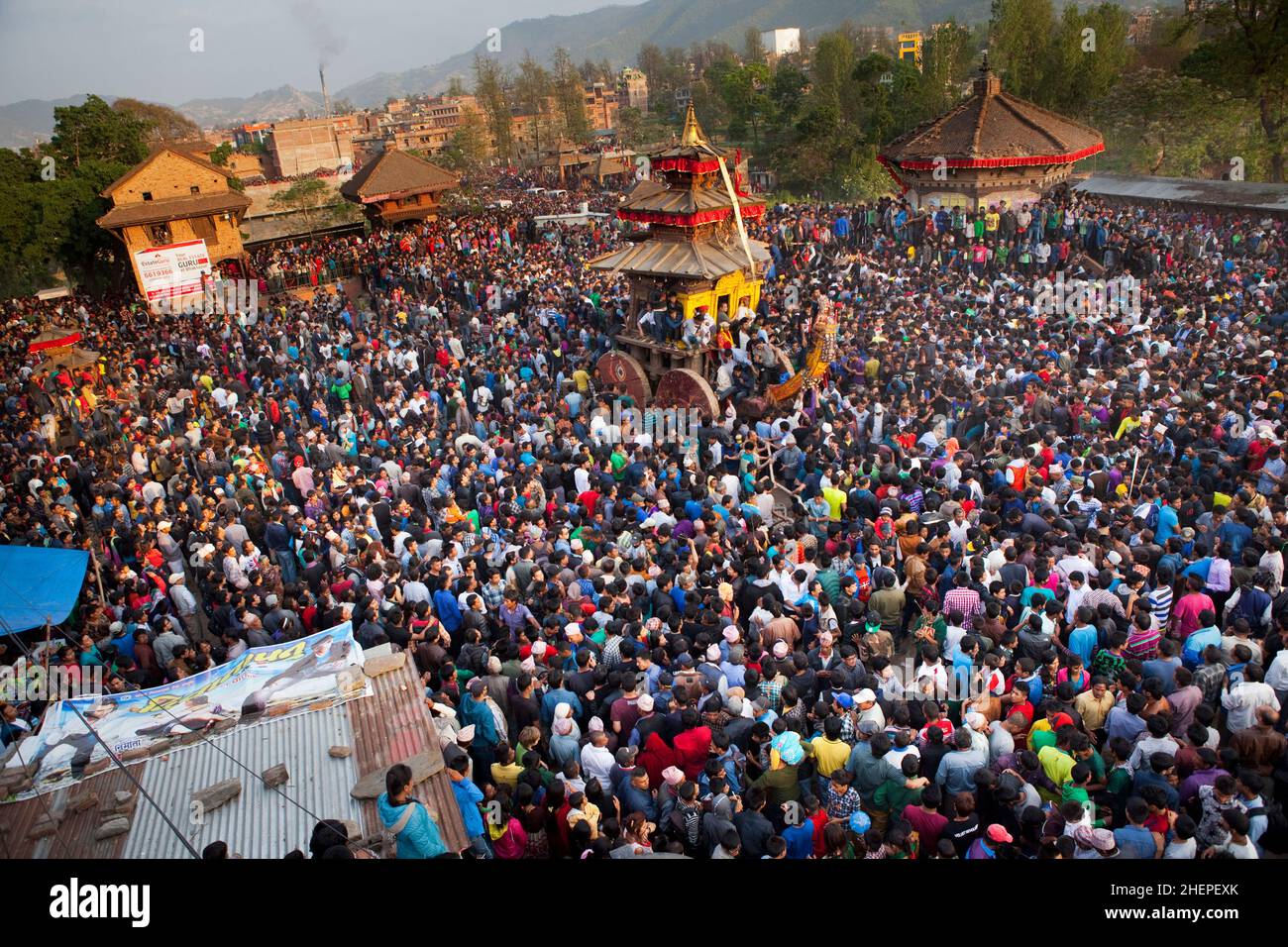 Residents hall a multi-tonne wooden chariot through the streets of ...