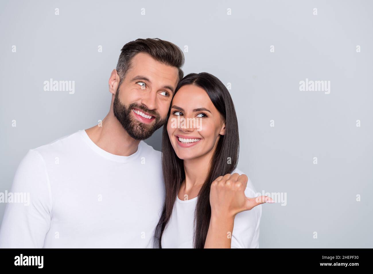 Photo of impressed millennial couple look promo wear white shirt ...