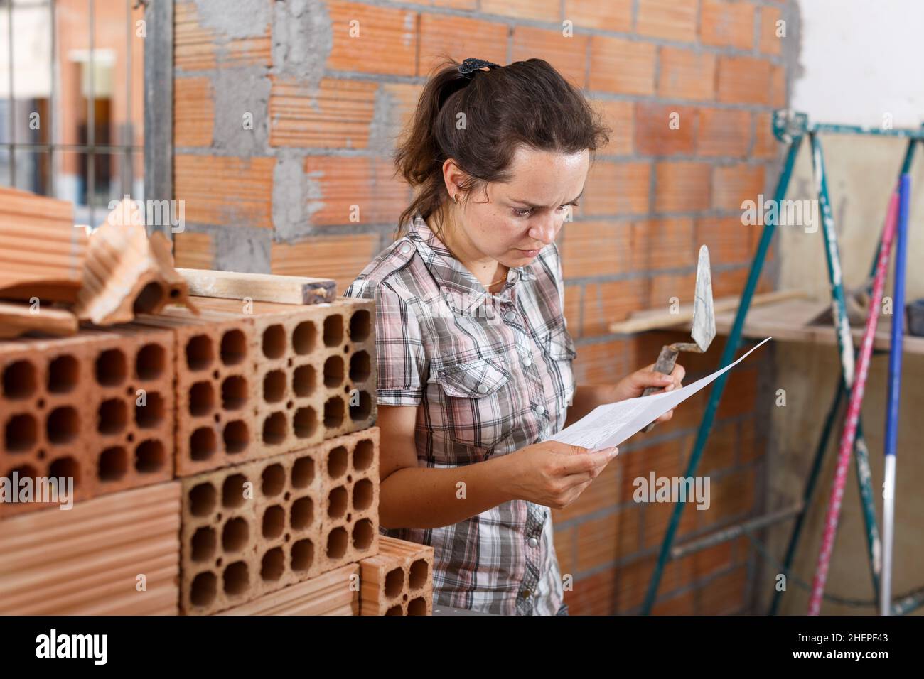 Woman looking at list hi-res stock photography and images - Alamy