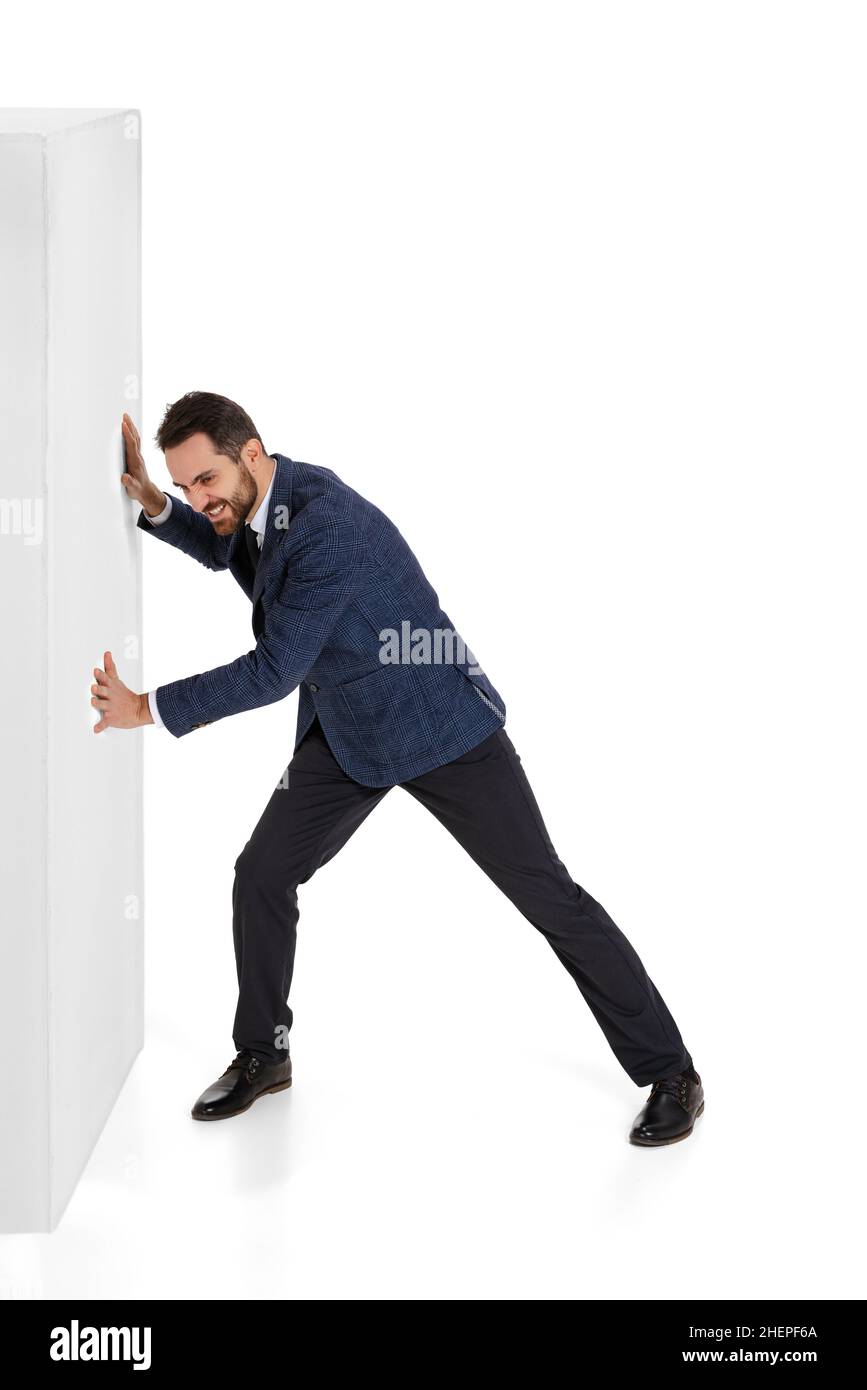 Full-length portrait of businessman, office worker, employee pushing ...