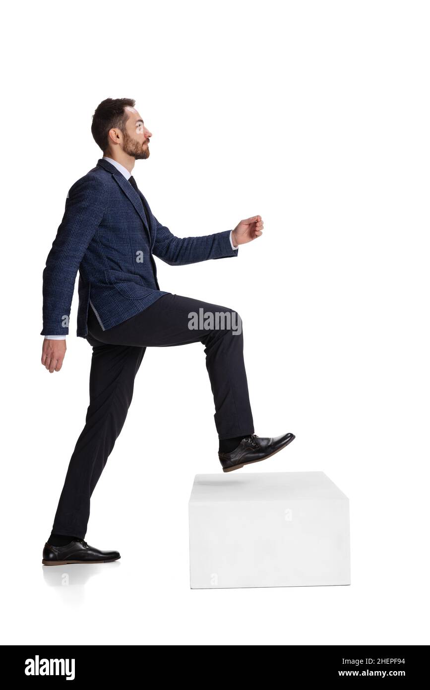 Full-length portrait of businessman, office worker making steps ...