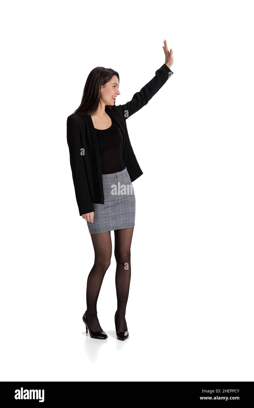 Full-length portrait of young woman, office worker waving hand in ...