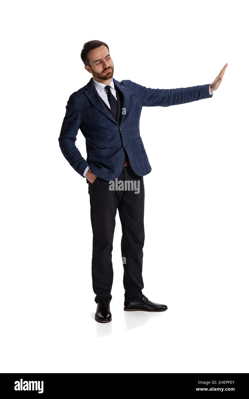 Full-length studio shot of man, office worker with outstretched arm ...