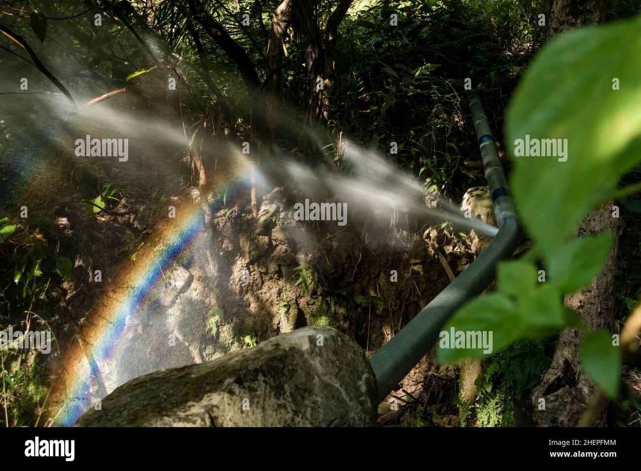 A shot of rainbow formed after dispersion of light by a water spray ...