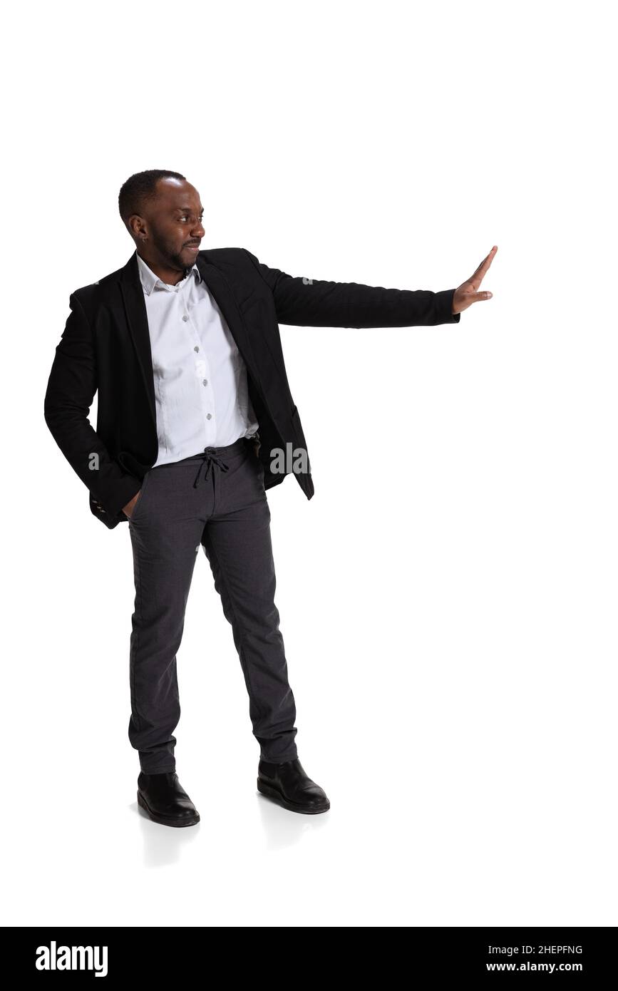 Full-length studio photo of man, office worker with outstretched arm ...