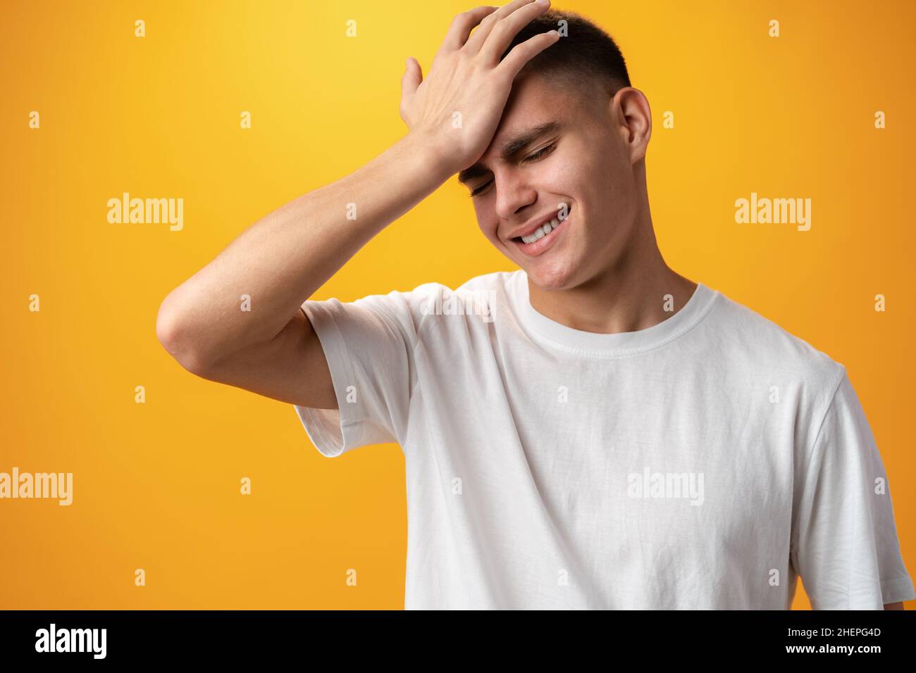 Sad teenager boy failed, touching face against yellow background Stock ...