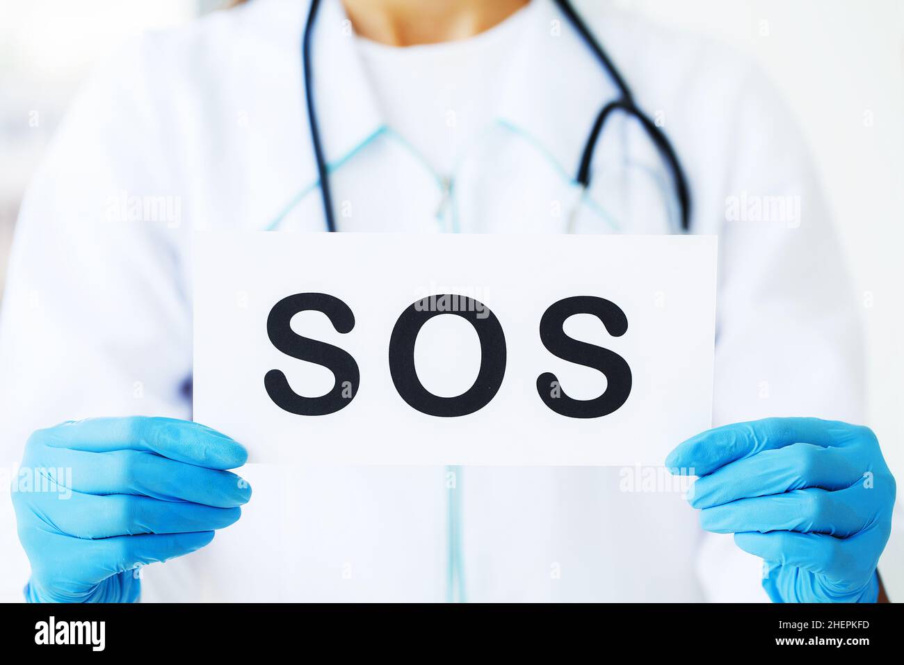 Doctor Holding a Card With Symbol Sos Stock Photo - Alamy