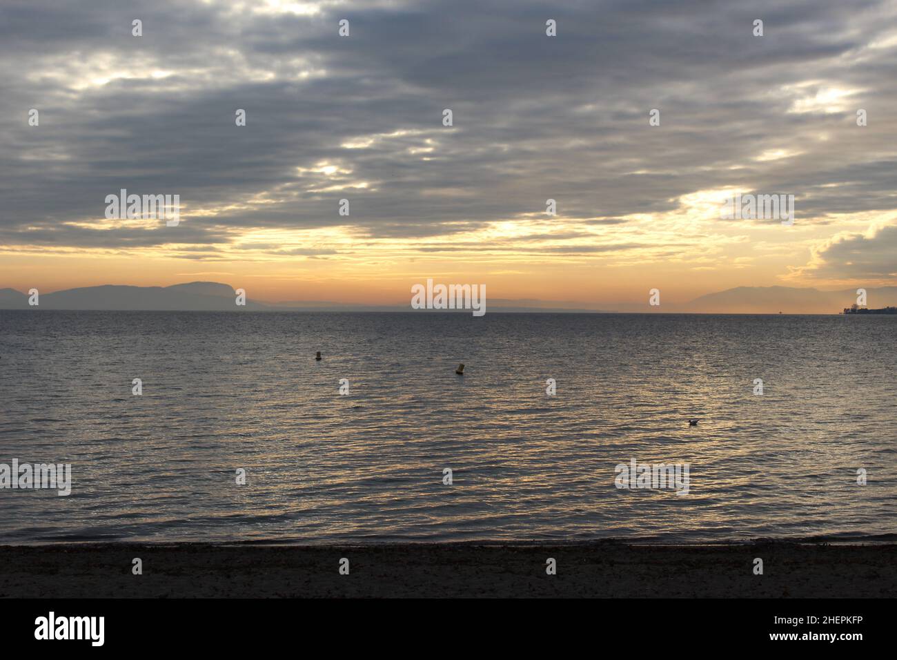 Sunset over Lake Geneva. Cloudy sunset with mountain silhouettes on the ...