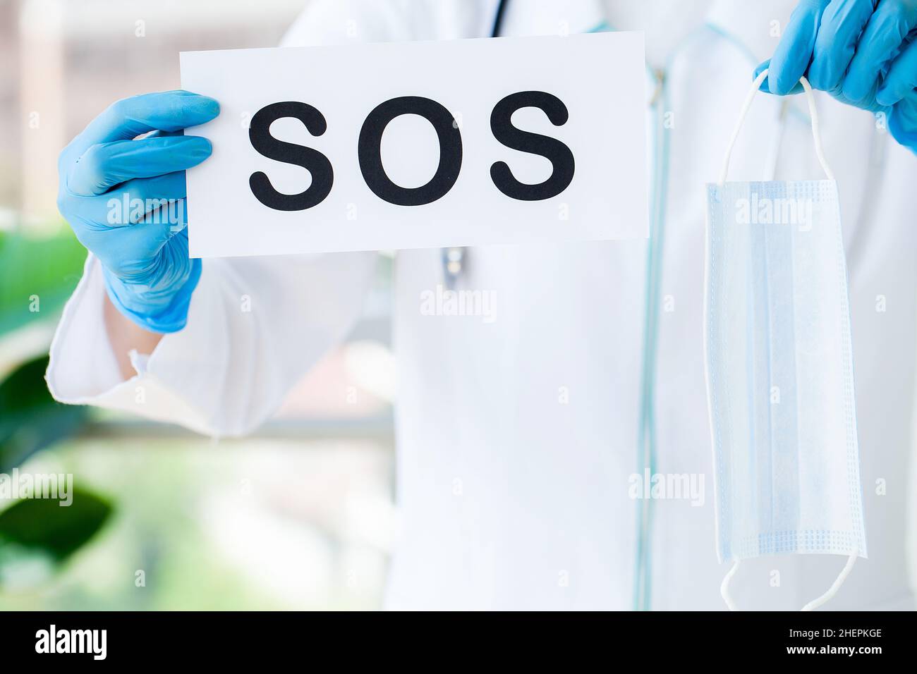 Doctor Holding a Card With Symbol Sos Stock Photo - Alamy