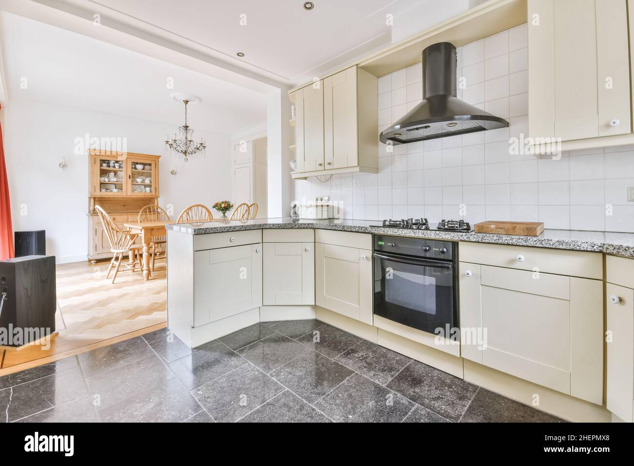 Large kitchen with beige kitchen unit and tiled floor Stock Photo - Alamy