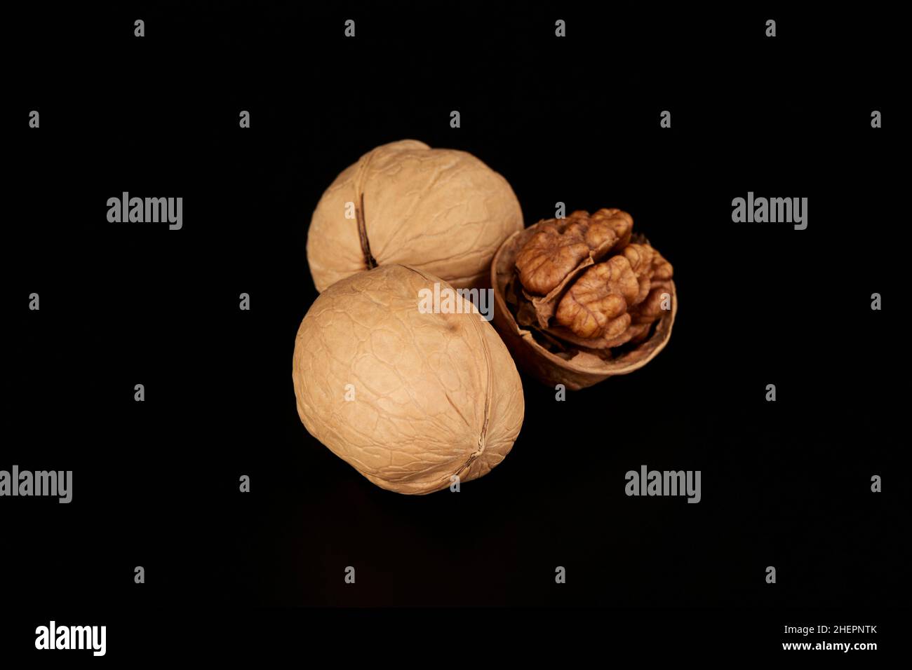 Two walnuts in shell and odi without shell lies next to each other in a ...