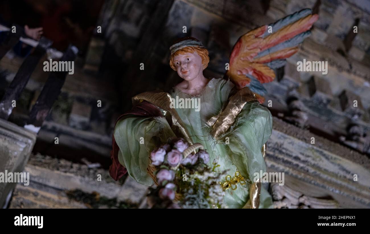 detail of Nativity scene: angel with colored wings and green dress ...