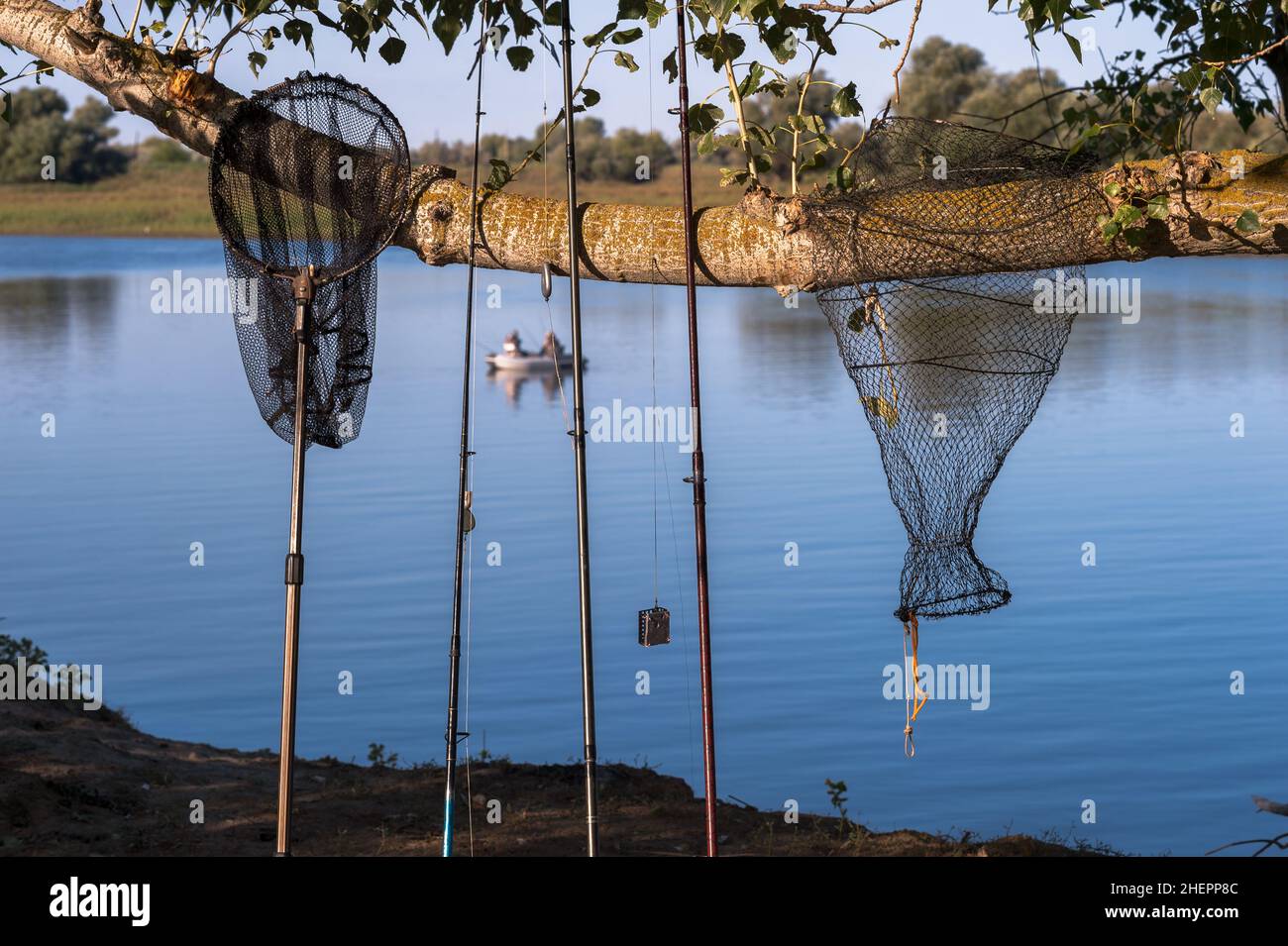 Fishing bottom gear in a row against the background of a large river ...