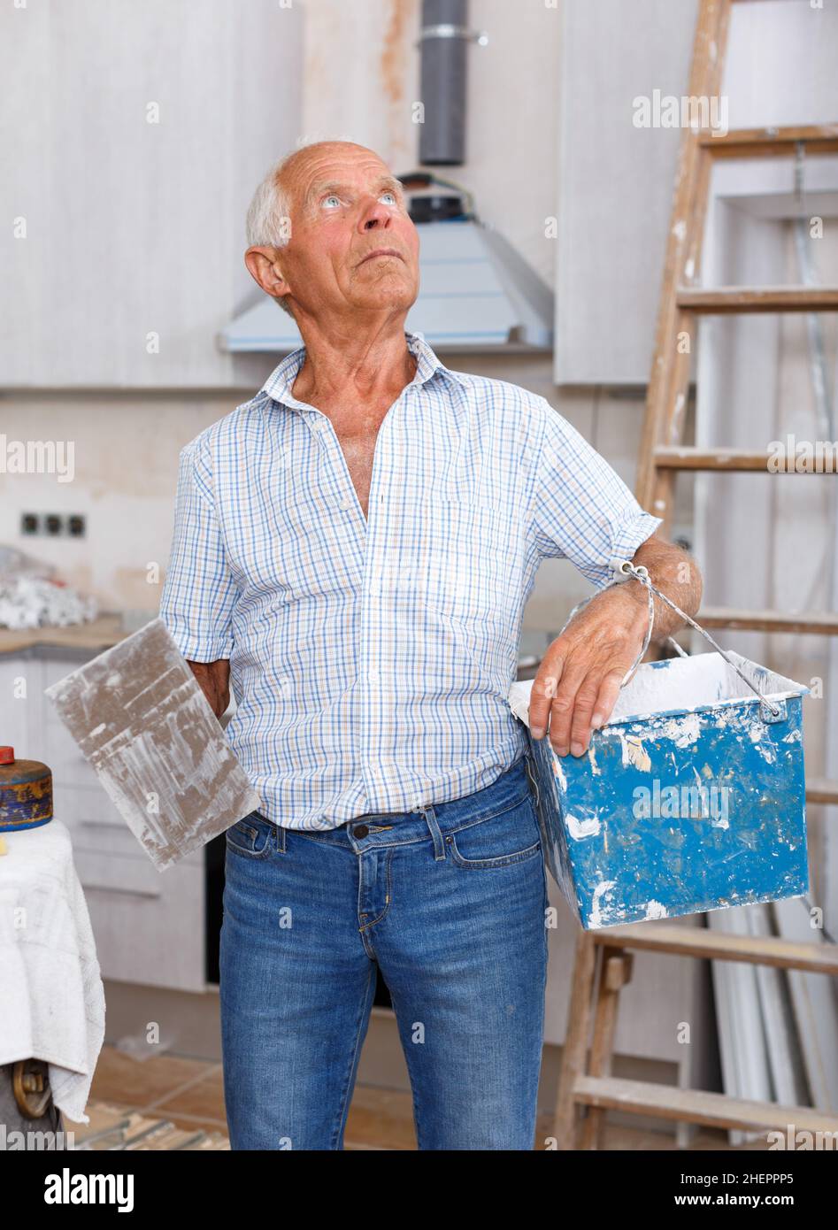 Man determining scope of plastering works Stock Photo - Alamy