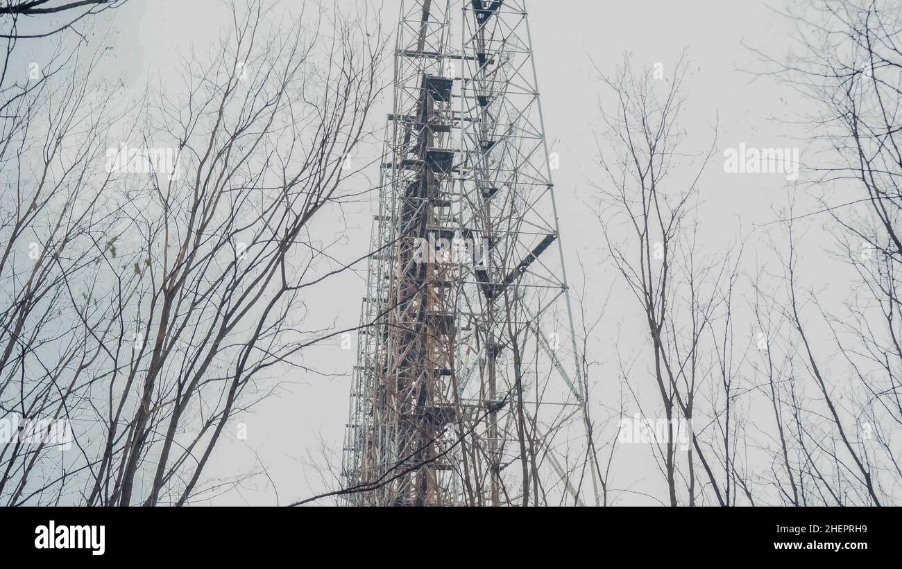 abandoned radio station and trees in chernobyl zone under grey sky ...