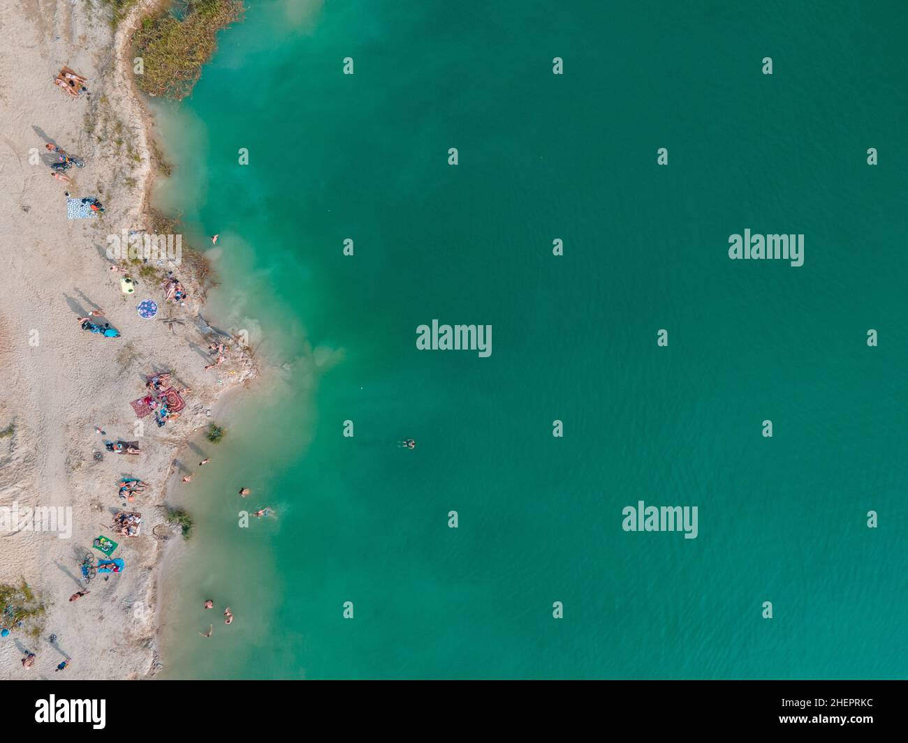 aerial view of people swimming in blue azure water sunbathing resting ...