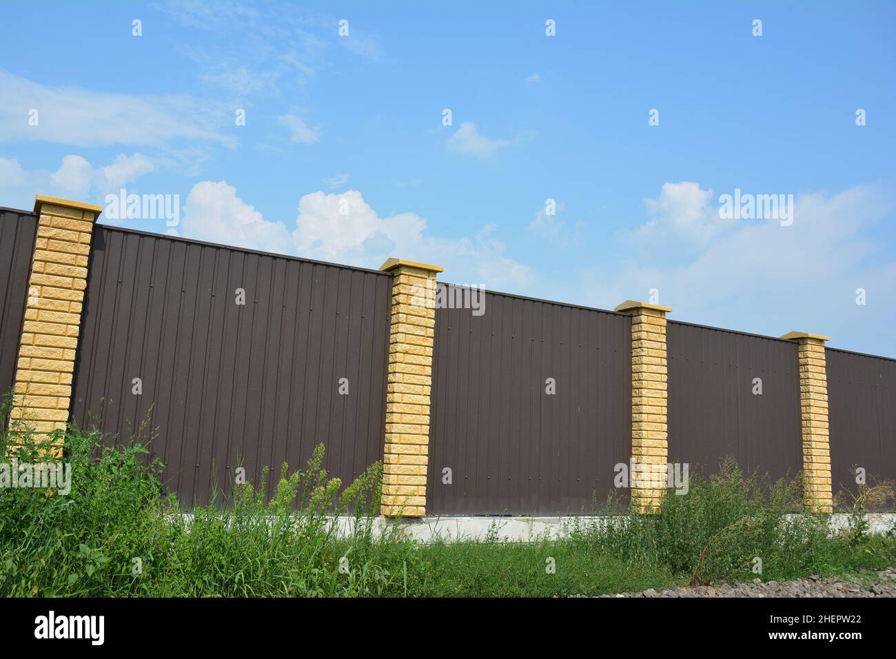 Building new Long metal fence on the suburban street side Stock Photo ...
