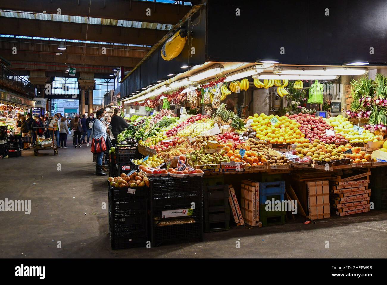 People shopping at a fruit and vegetable counter in the covered ...