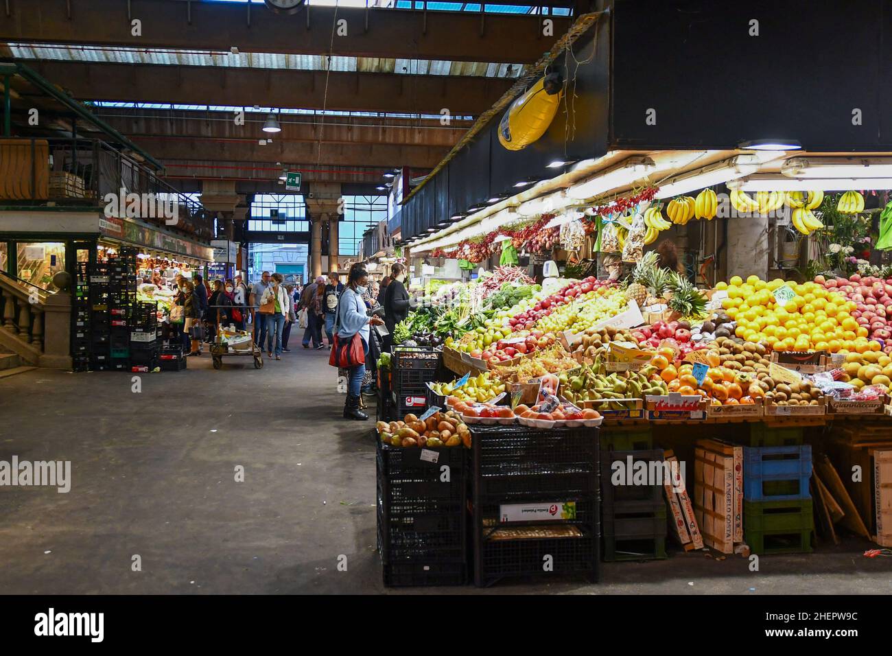 People shopping at a fruit and vegetable counter in the covered ...