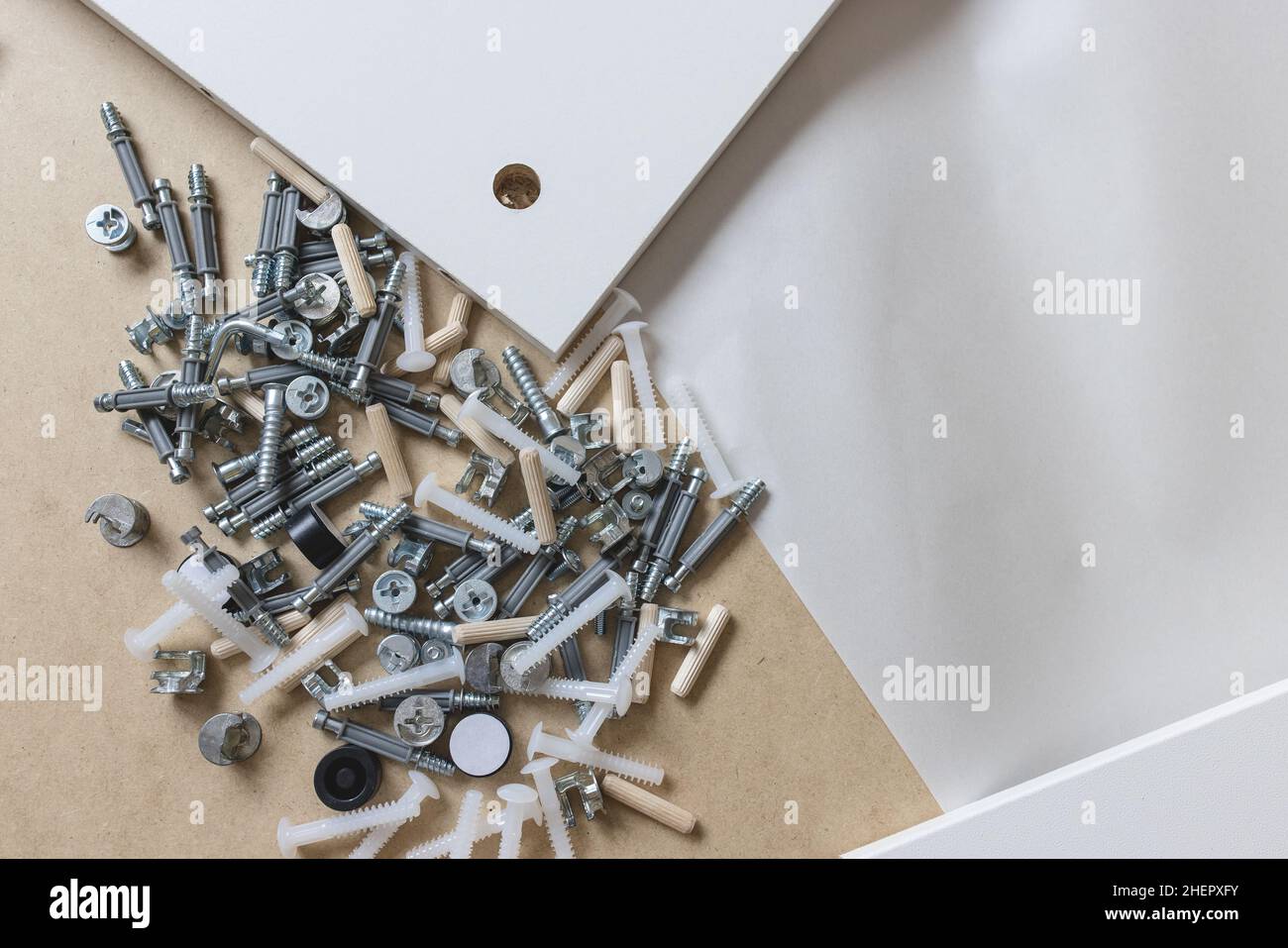 Opened box with furniture assembly parts and tools on the floor. Self ...