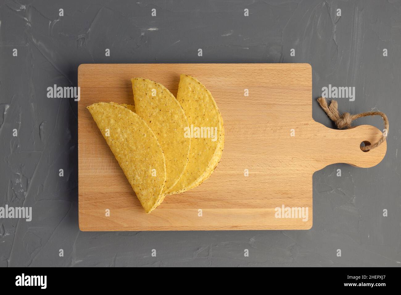 Three empty taco shells ingredient. Mexican corn tortilla on wooden ...