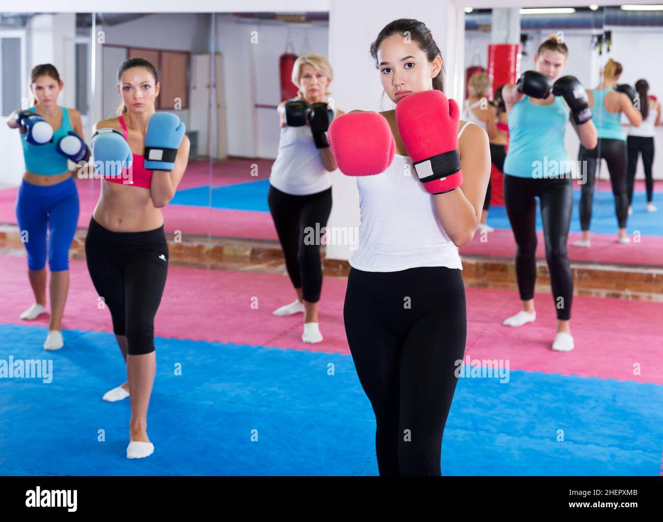 female who is training box exercises in group Stock Photo - Alamy