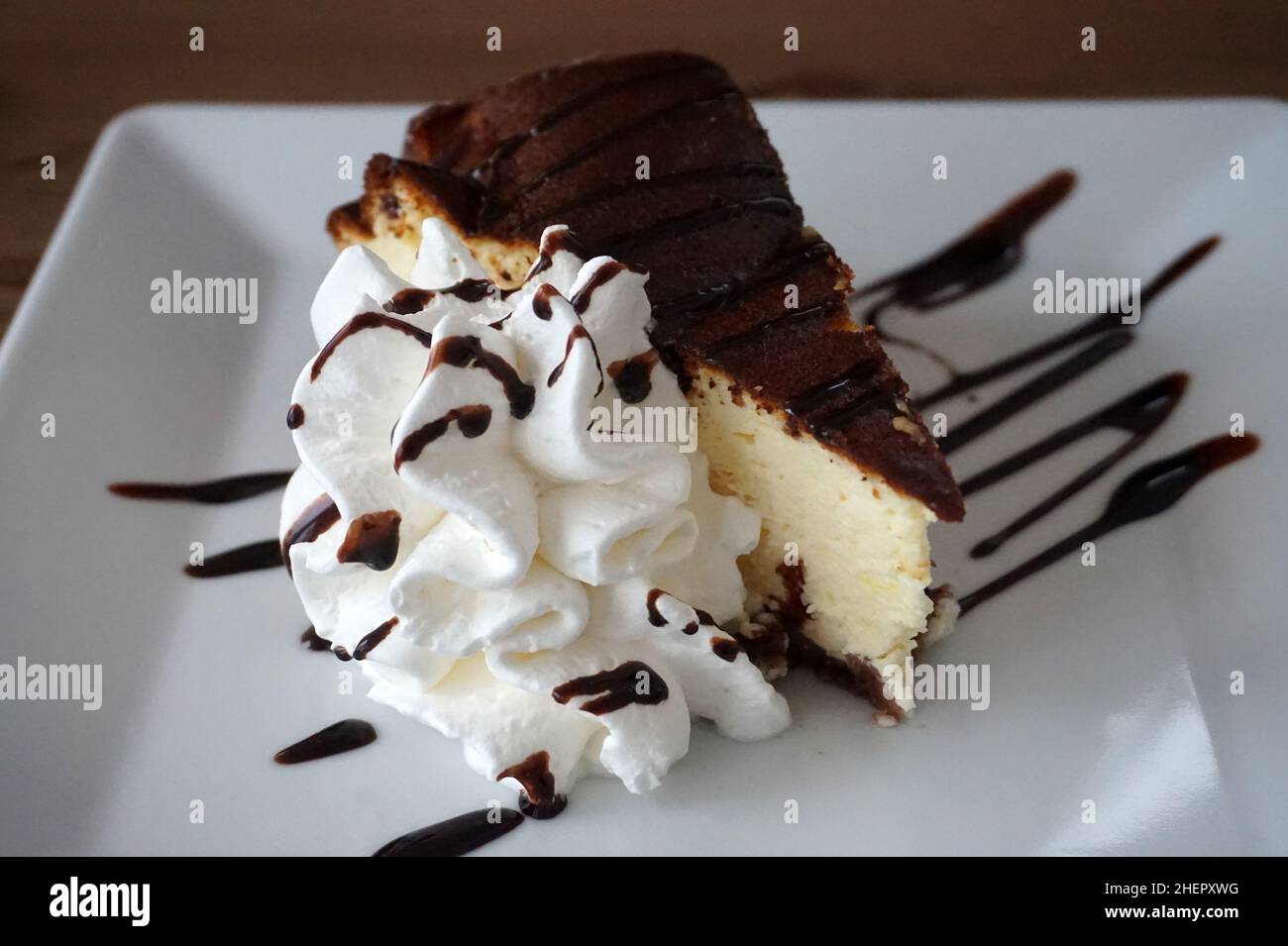 Triangular slice of cake with whipped cream Stock Photo - Alamy