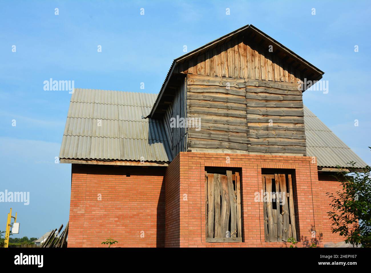 Building brick house construction with asbestos roofing Stock Photo - Alamy