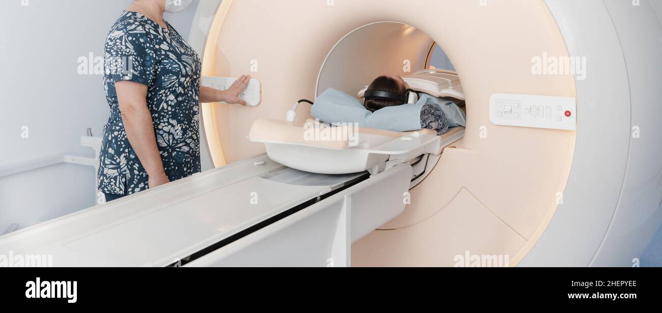 Doctor or nurse and patient with tomography CT or MRI Scan in hospital ...