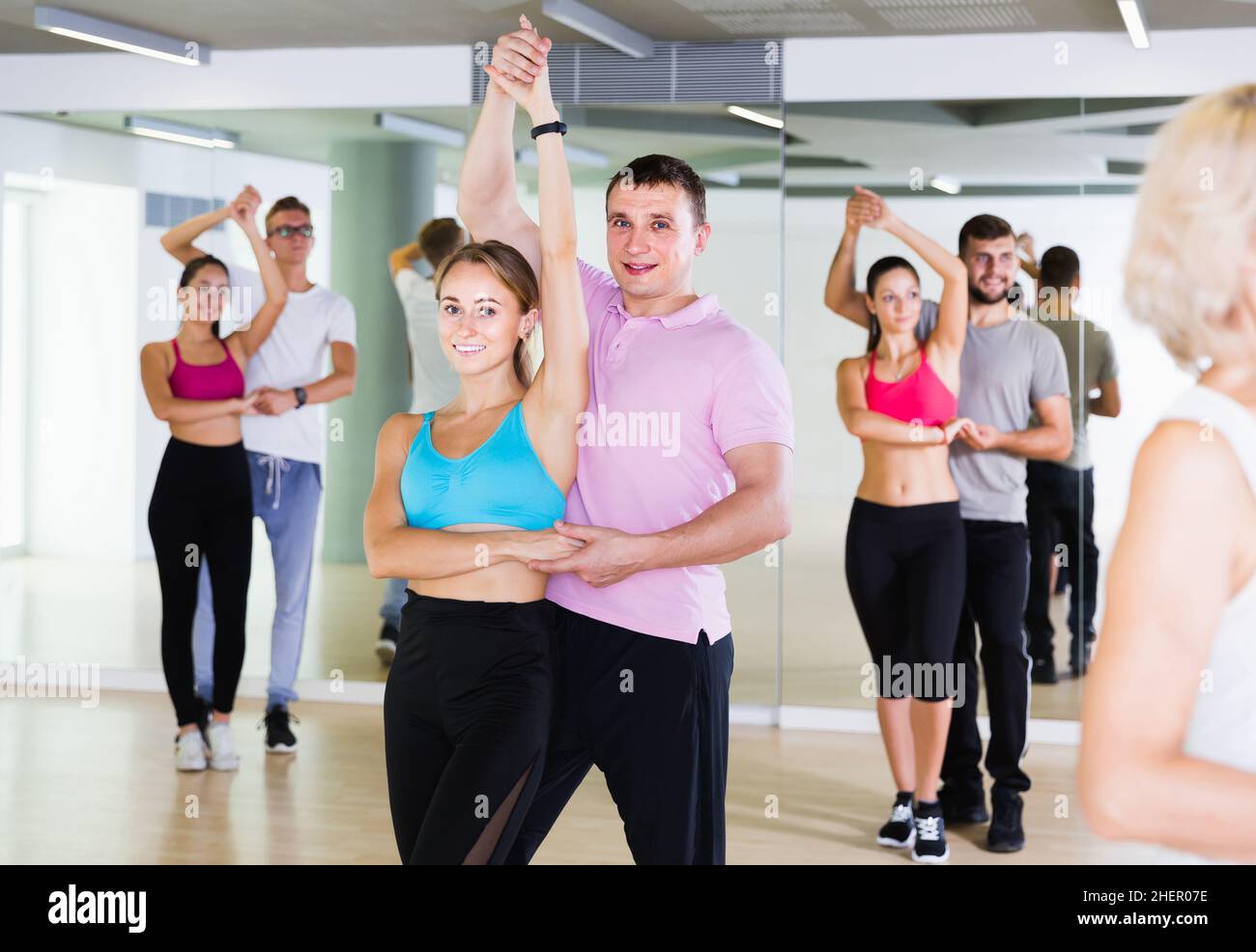 Dancing couples learning salsa at dance class Stock Photo - Alamy