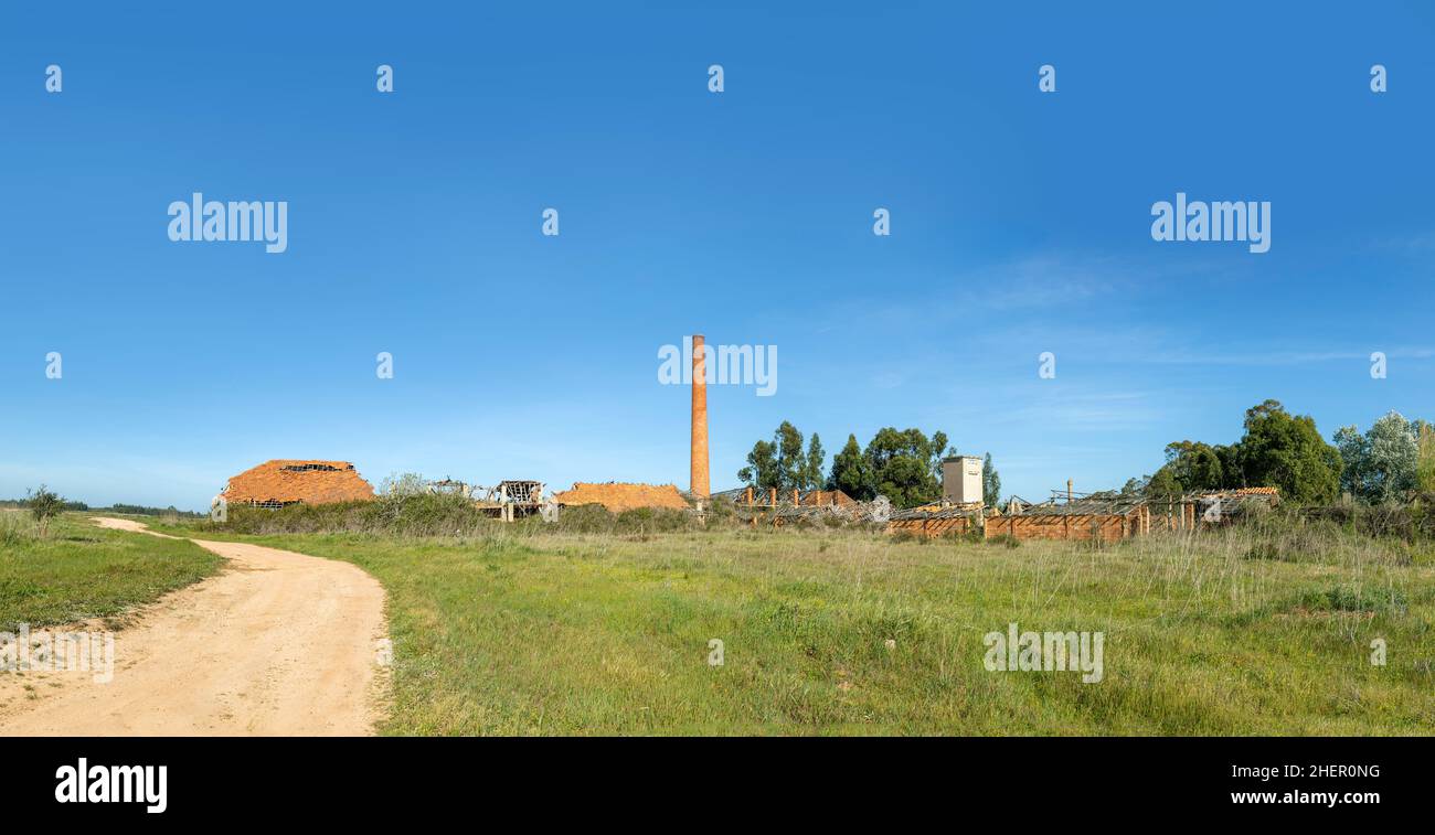 old rotten factory with damaged roof and old brick chimney in Sines ...