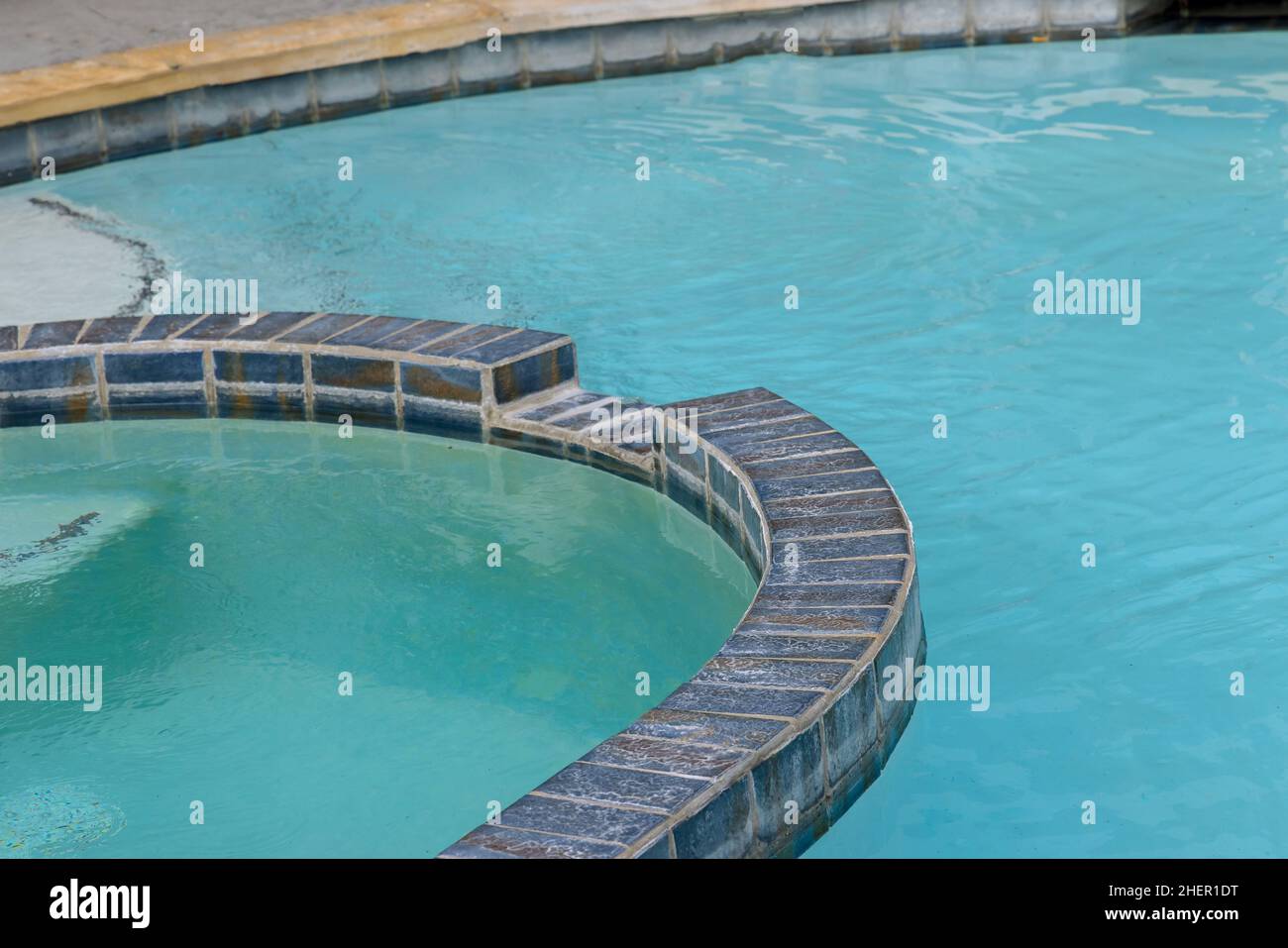 Empty swimming pool with blue water Stock Photo - Alamy