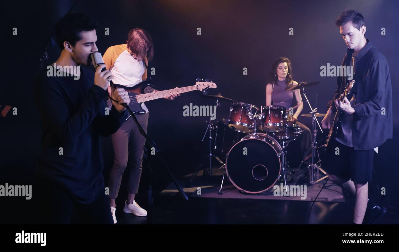 young singer performing song with music band on stage,stock image Stock ...