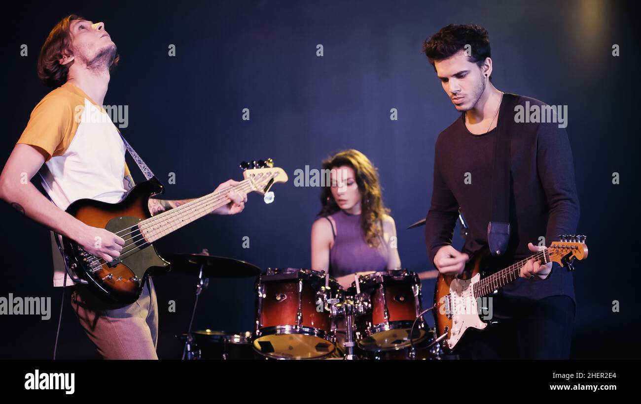 Handsome guitarists drummer performing on hi-res stock photography and ...