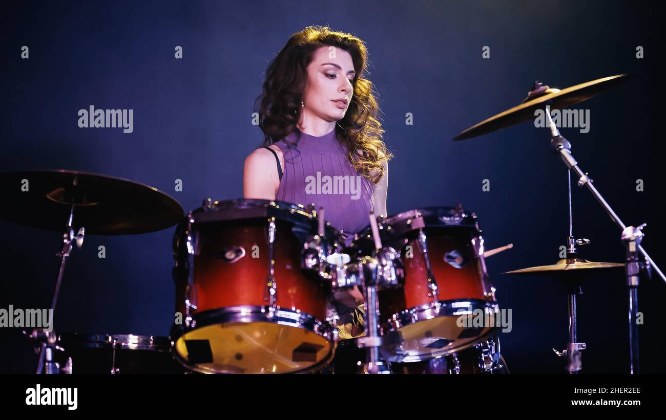 pretty drummer playing on drums during performance on stage,stock image ...