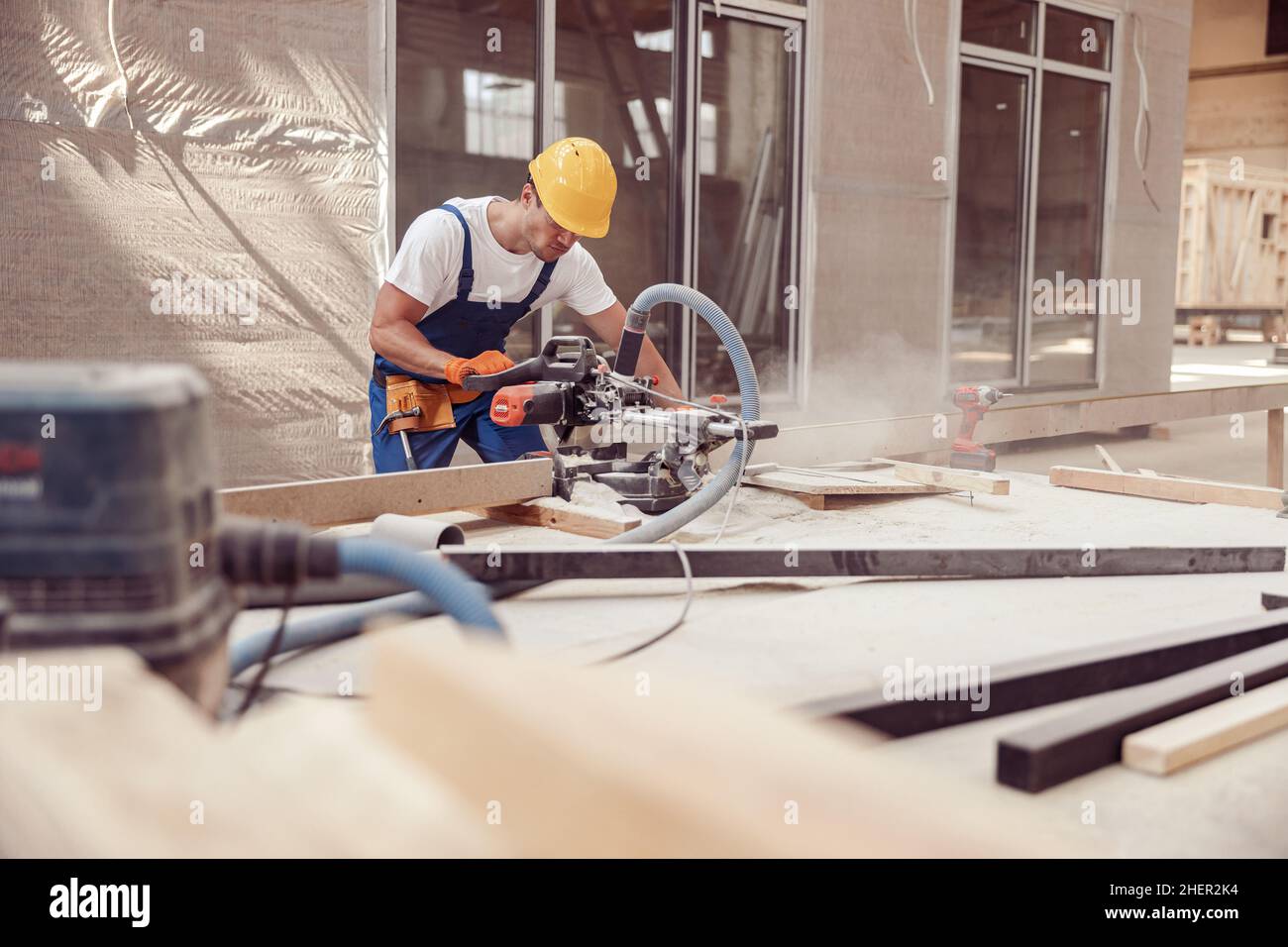 Male worker using wood cutting circular saw machine Stock Photo - Alamy
