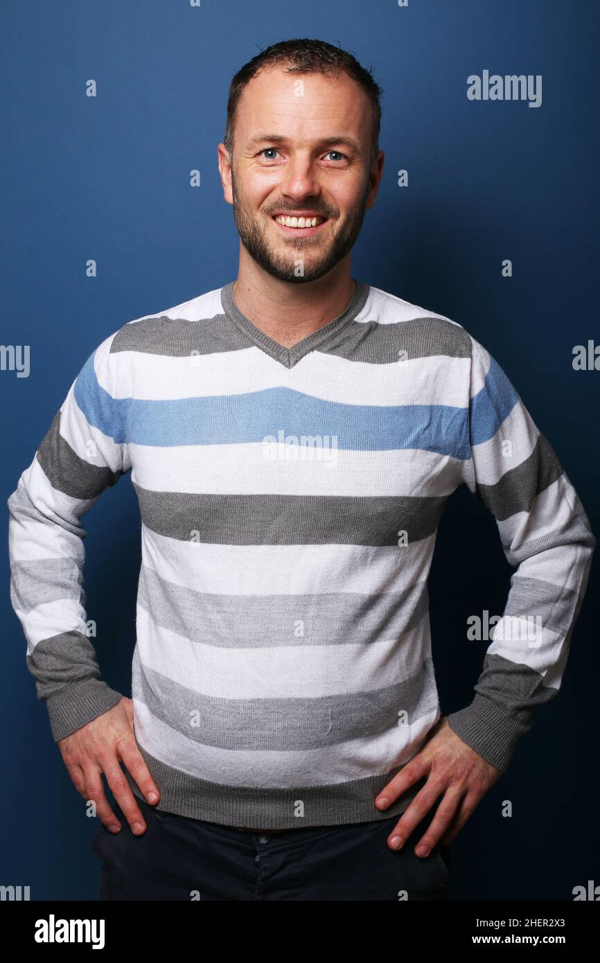 Portrait of a beautiful happy man in front of a colored background ...