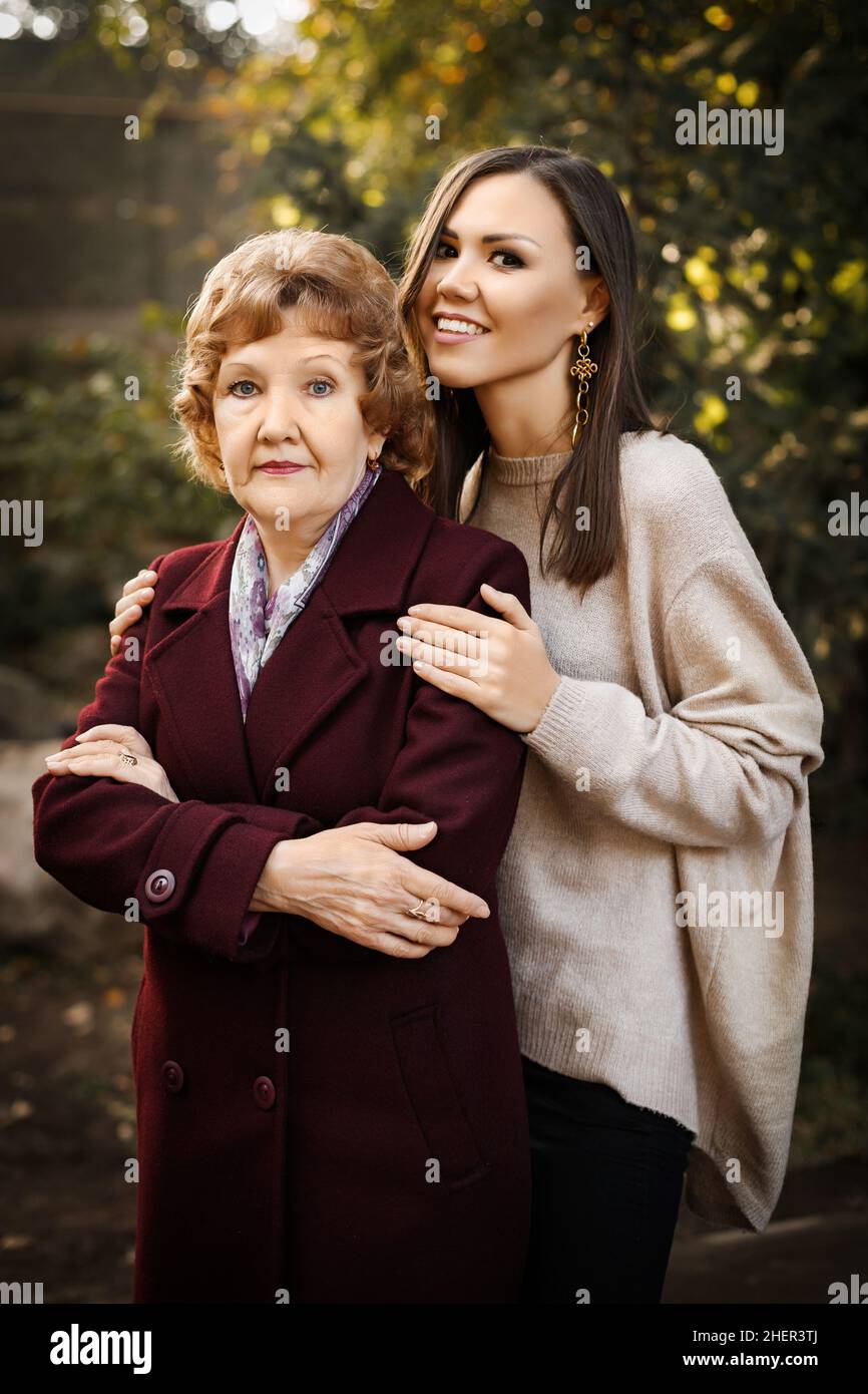 Mom hugging daughter walking hi-res stock photography and images - Alamy
