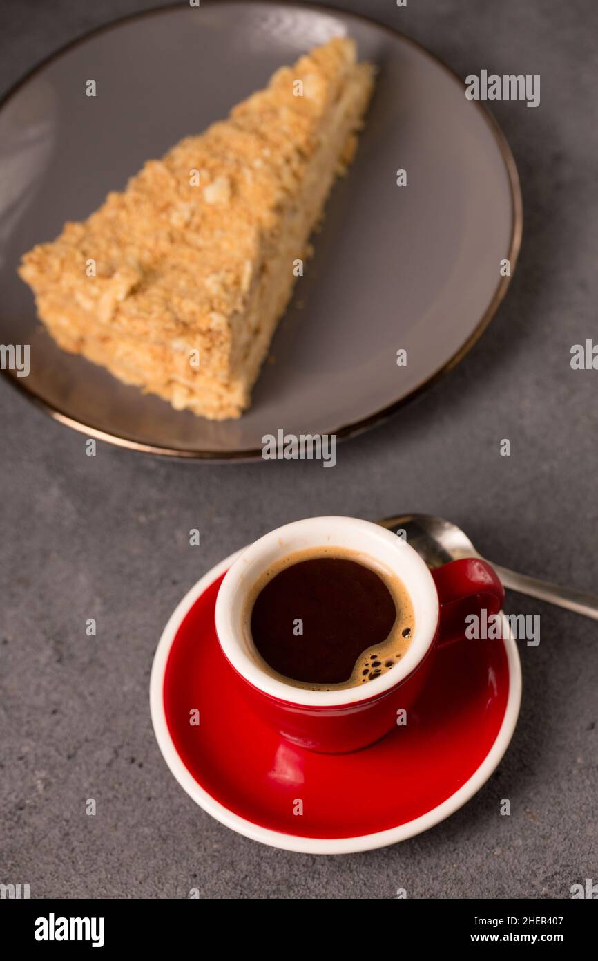 coffee expresso in a red coffee cup with a slice of delicious napoleon ...
